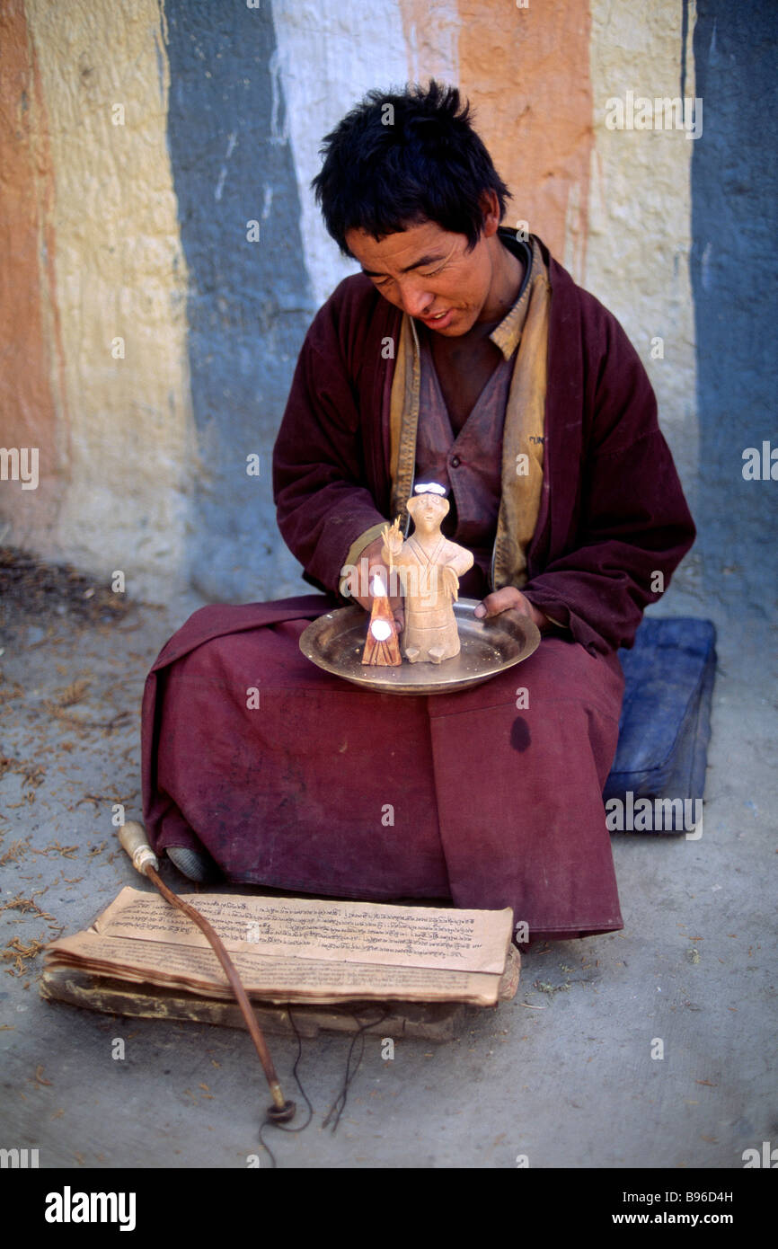 Nepal, Mustang District, Gami village, monk making a torma or ritual ...