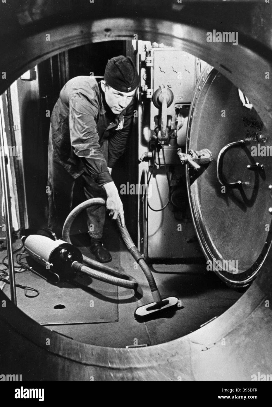 A sailor doing morning clean up on a nuclear powered submarine Stock ...