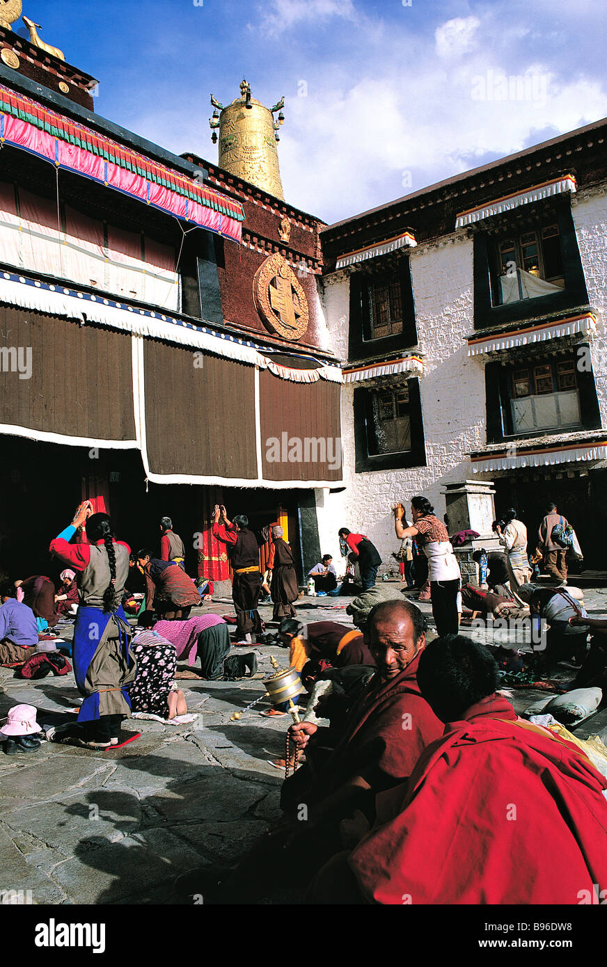 China, Tibet Autonomous Region, Lhasa, pilgrims in prayer in front of ...