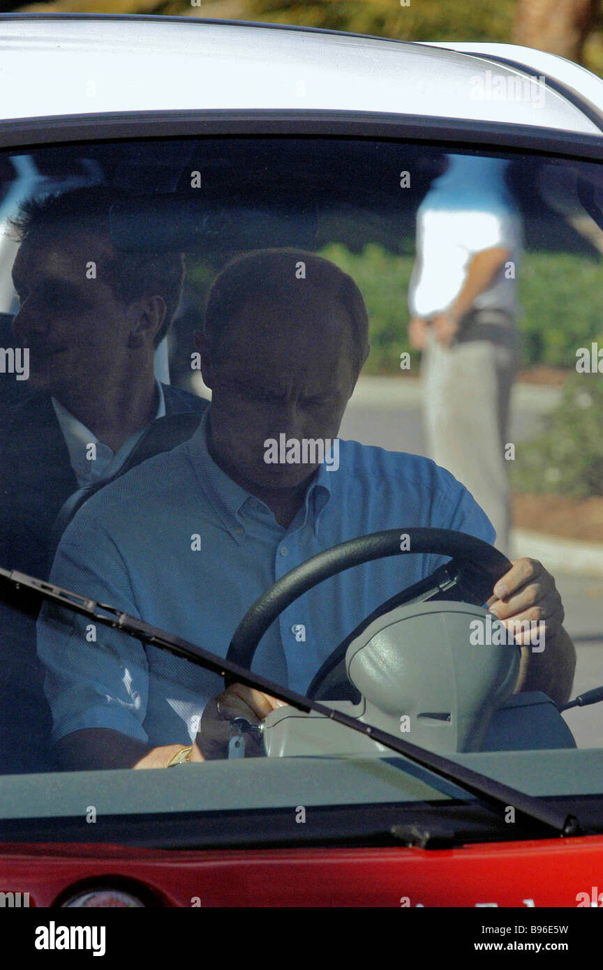 Russian President Vladimir Putin driving in an electromobile to his ...