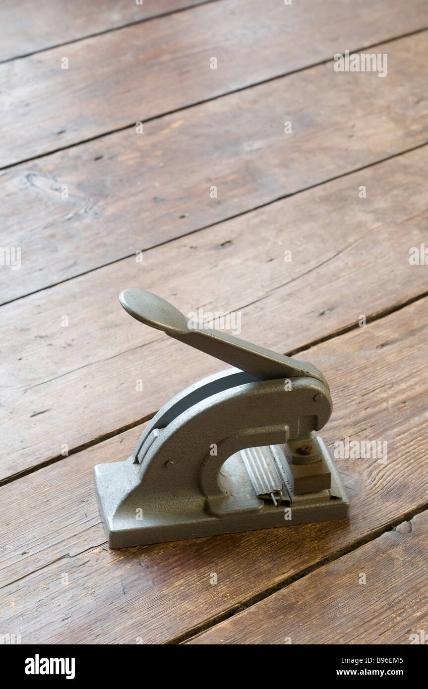 Old company seal press for embossing documents on a wooden floor Stock ...
