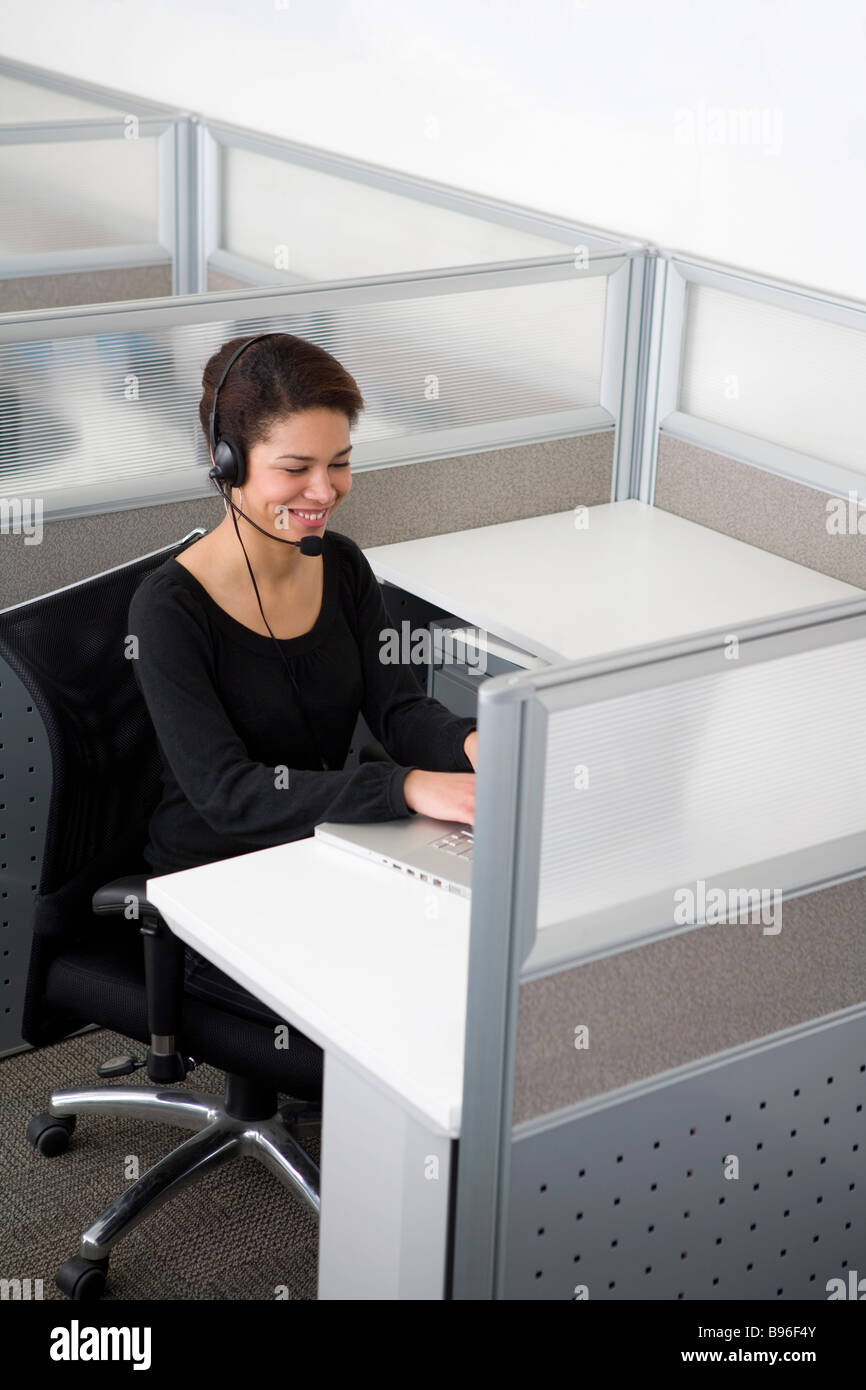 Woman typing in office cubicle hi-res stock photography and images - Alamy
