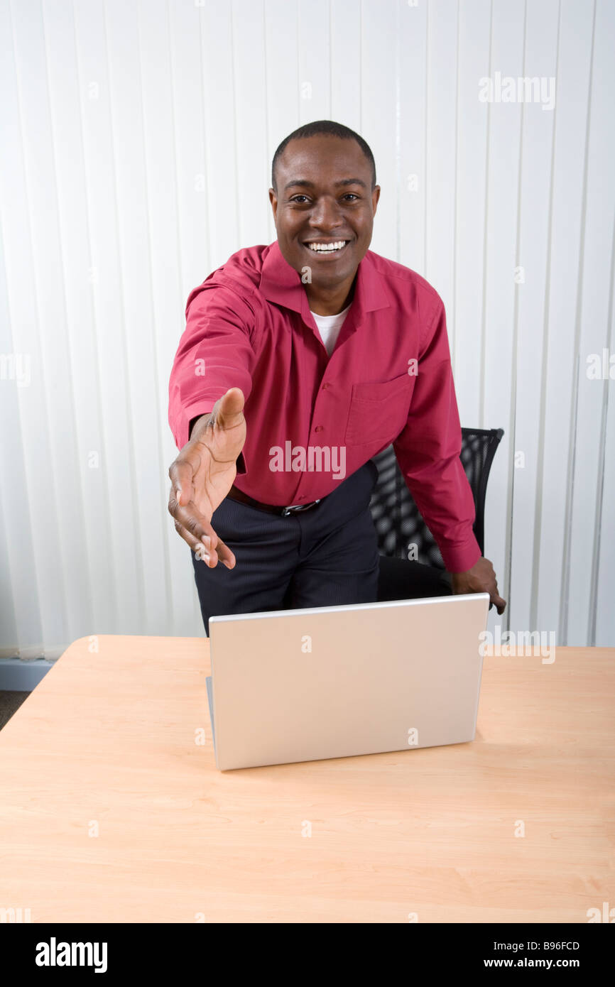 Businessman extending hand Stock Photo - Alamy