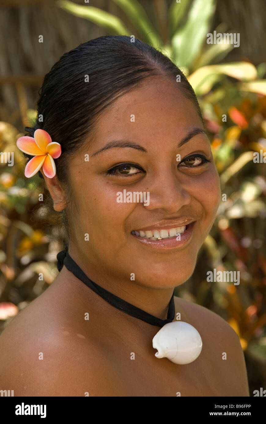 Tonga performer wears tricolor plumeria flower (Plumeria rubra) in her ...