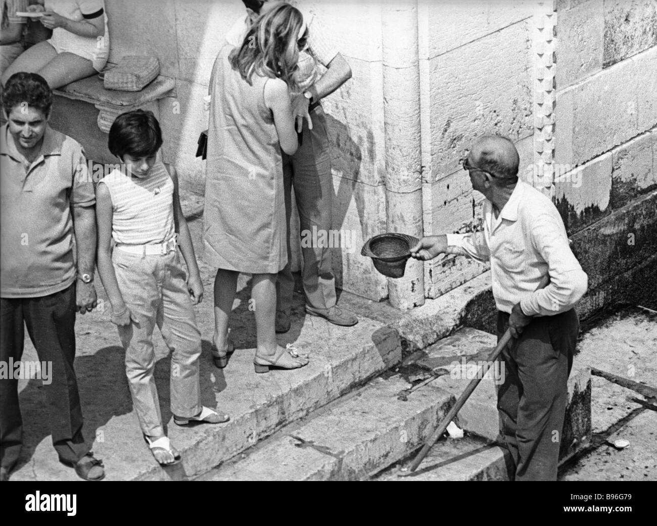 A beggar asks for alms in the streets of Venice Stock Photo - Alamy