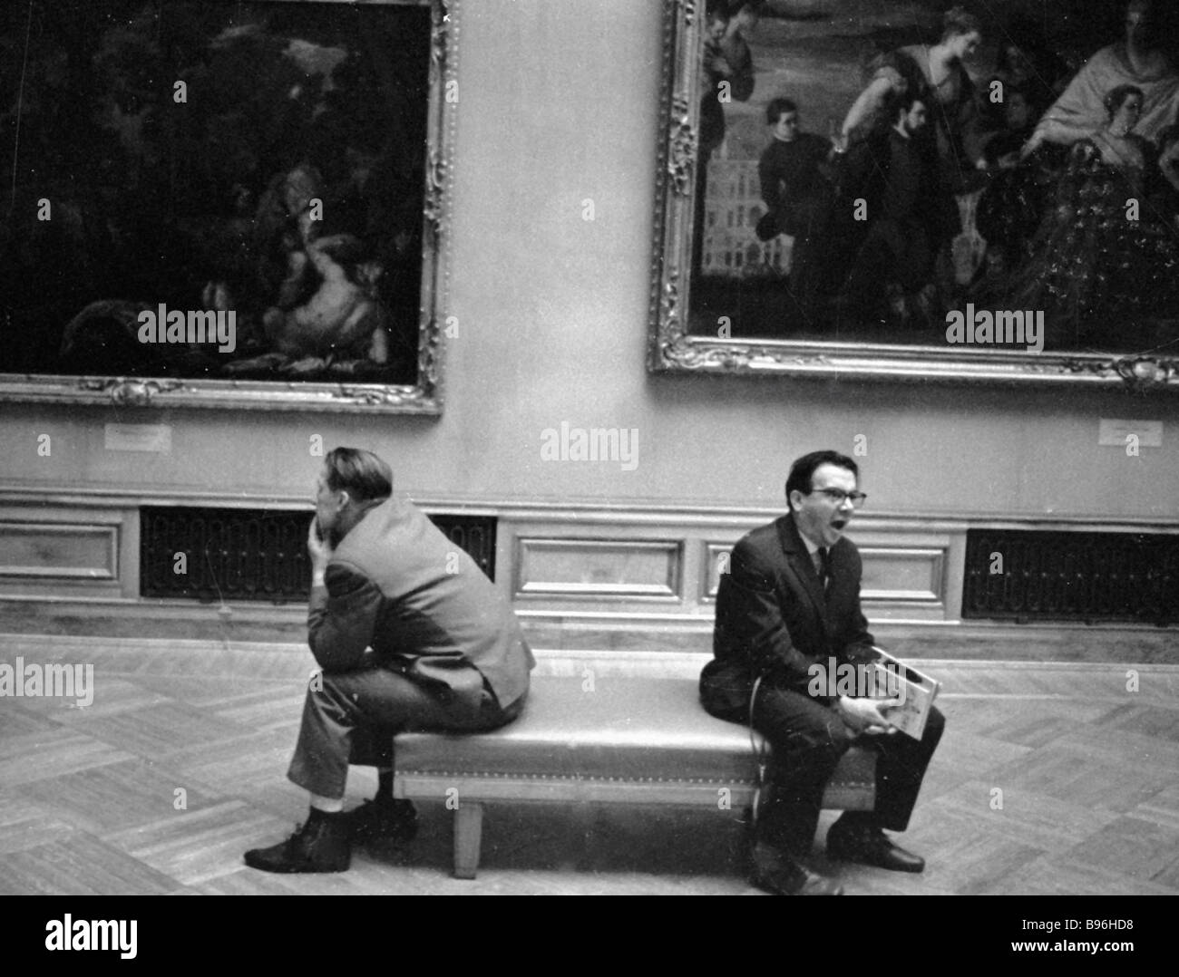Museum visitors taking a rest on a bench in the hall Stock Photo - Alamy