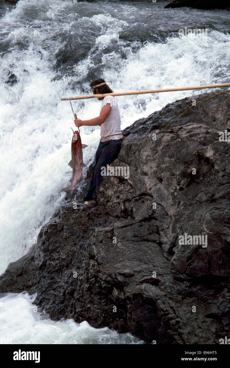 A Native Indian Fisherman fishing for Salmon with a Gaff in the Bulkley ...
