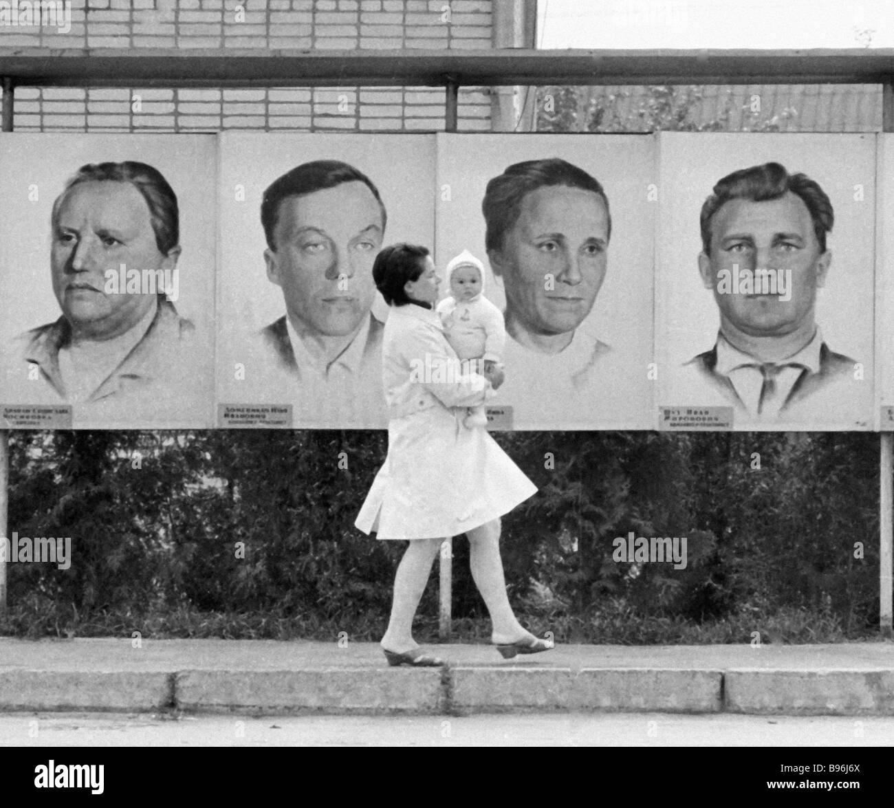 A woman and her child against the background of Heroes of Labor ...