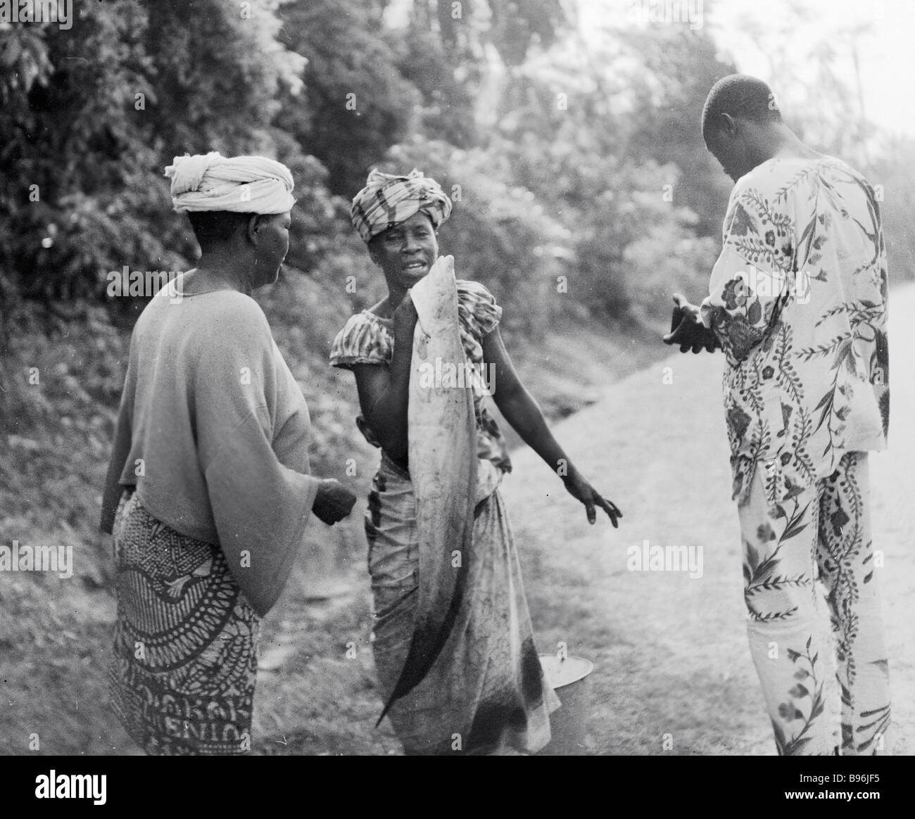 Fisherwoman sells harpooned fish Stock Photo - Alamy