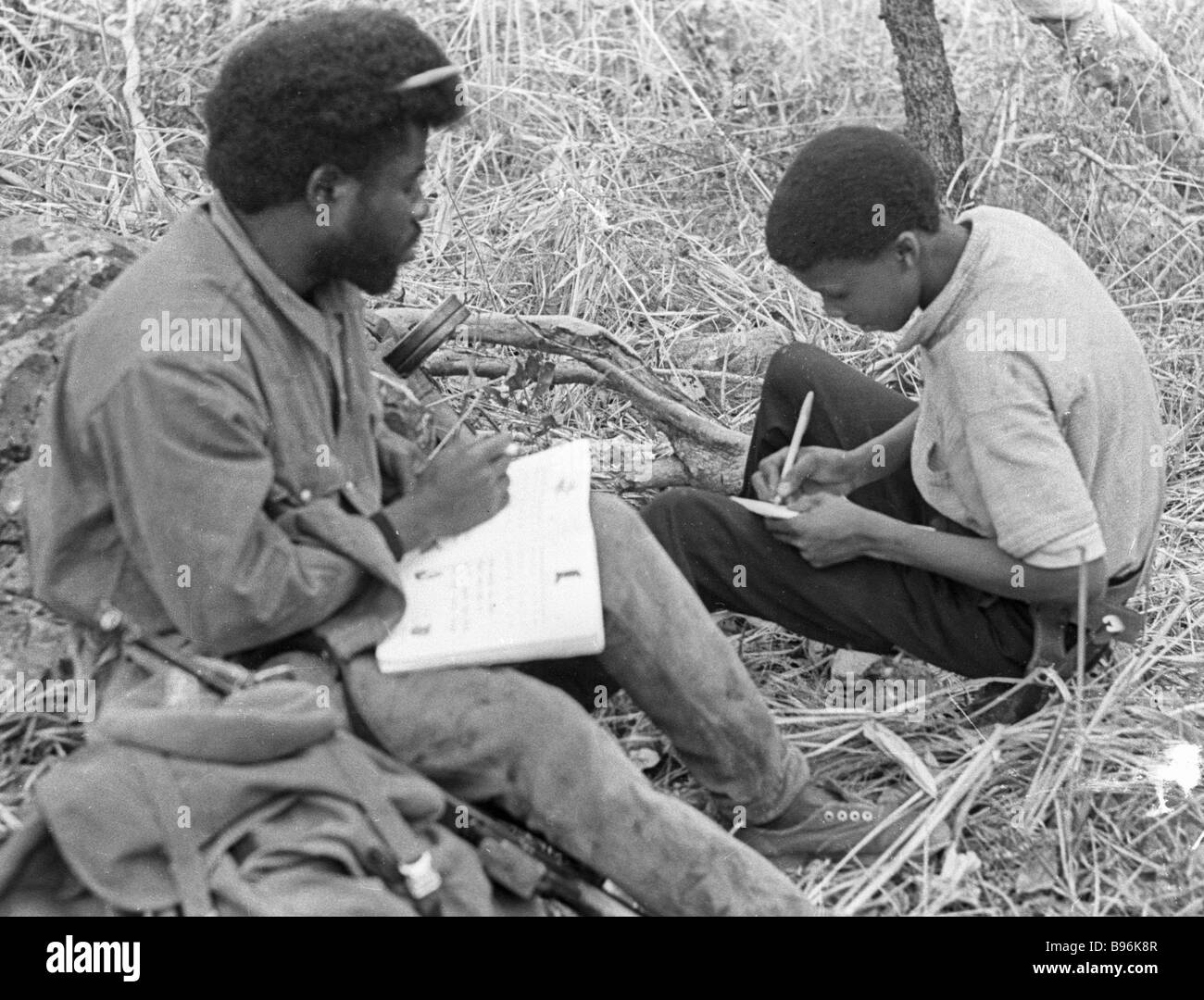 Political commissar left teaches a young guerrilla brigade member to ...