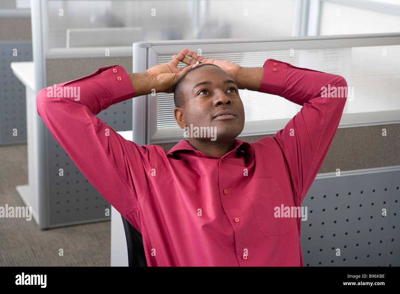 Businessman relaxing in office cubicle Stock Photo - Alamy