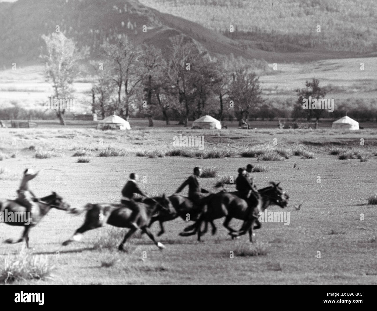 Khangai men galloping on horses Stock Photo - Alamy