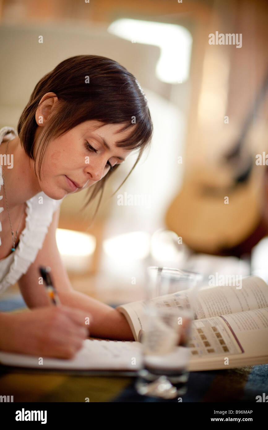 Young woman studying in urban loft Stock Photo - Alamy