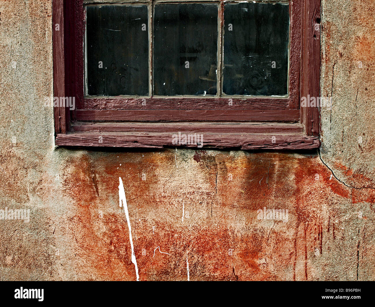 stucco wall with half of a window at the top, colored paint and rusting ...