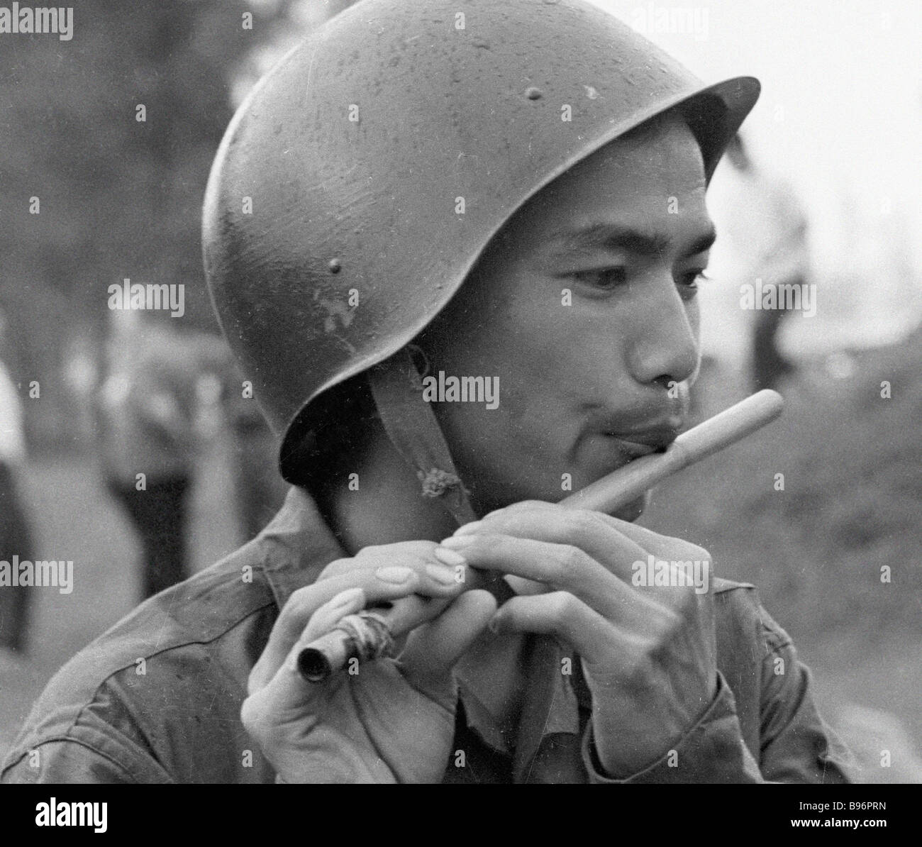 A Vietnamese soldier playing a reed pipe Stock Photo - Alamy