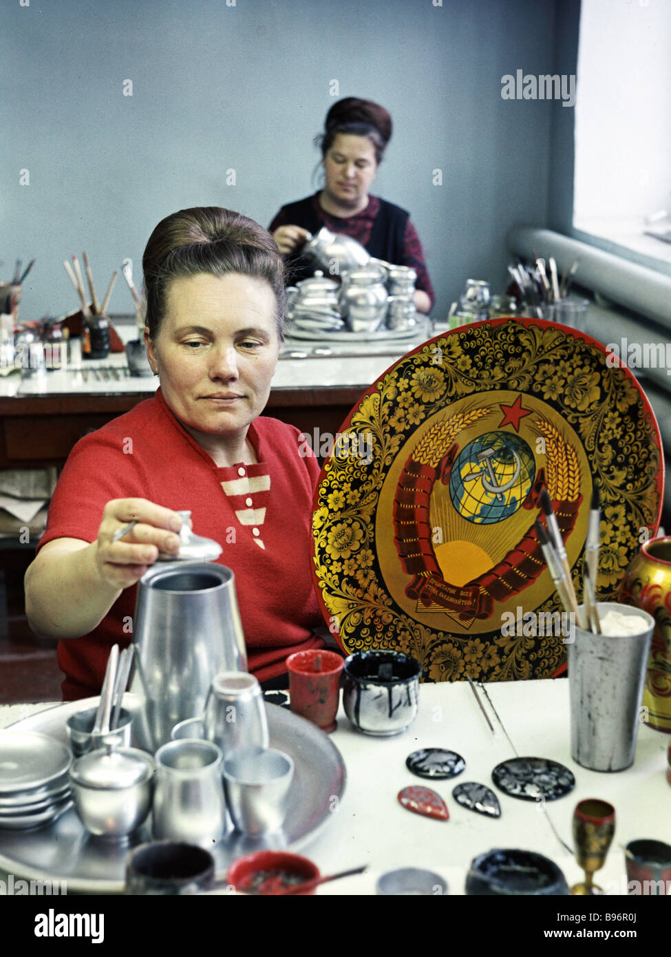 Handicraftswomen of the Semyonovsky artel painting trays Stock Photo ...