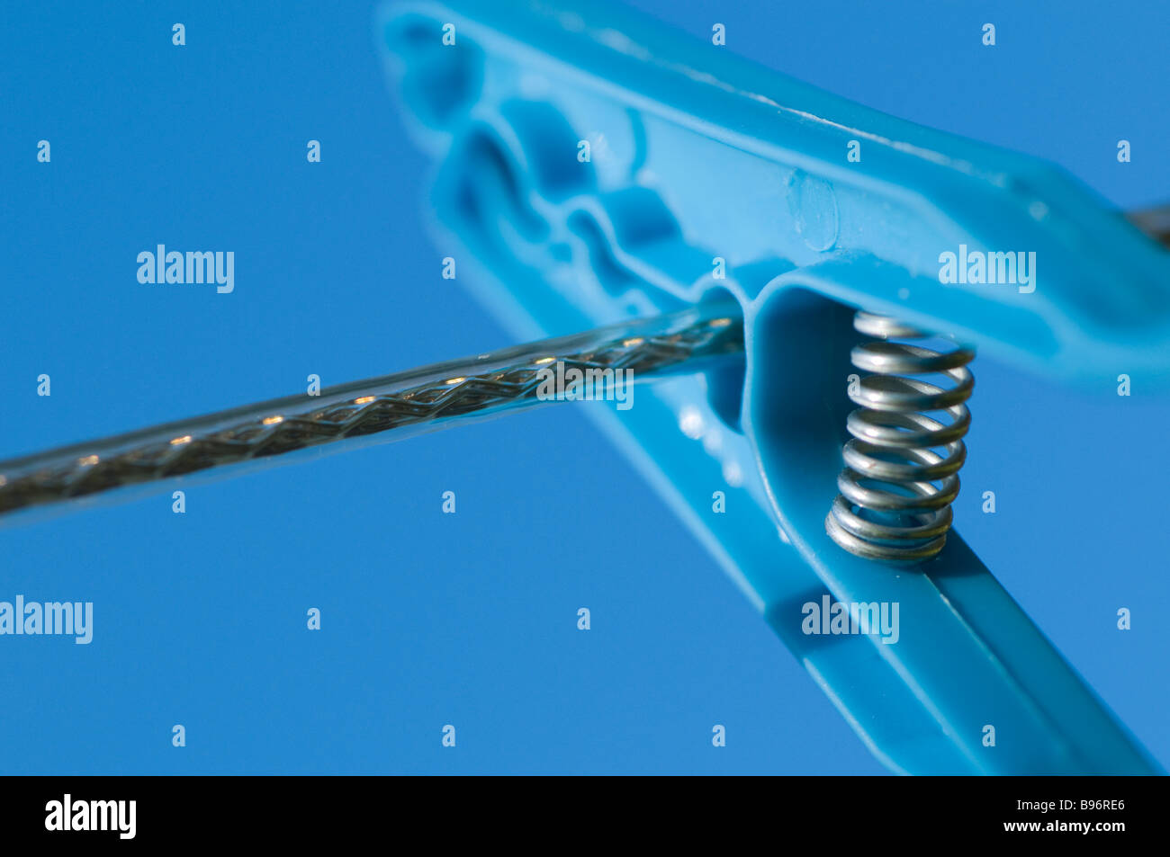 Blue peg on a washing line against a blue sky Stock Photo - Alamy