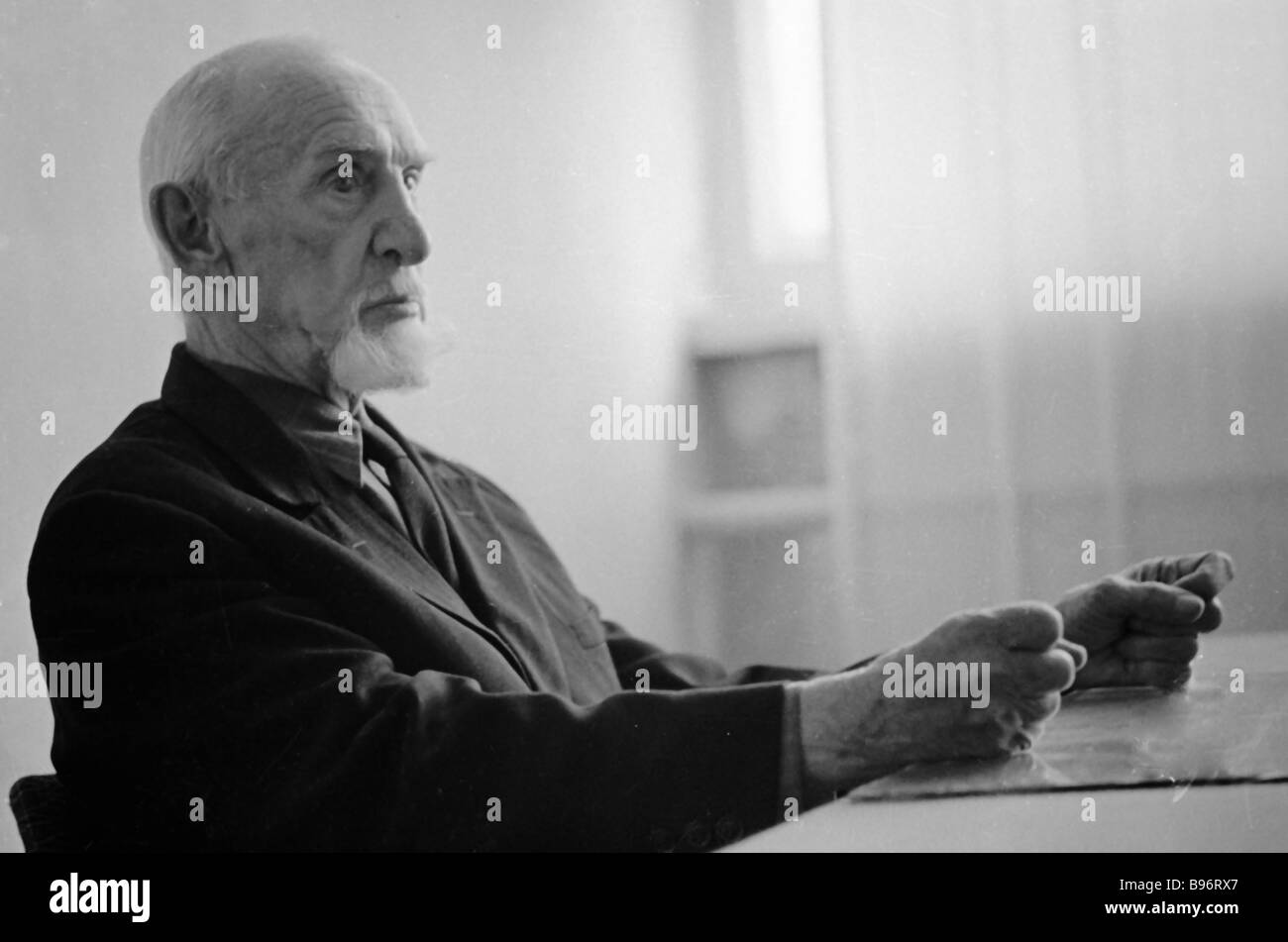 An old man at a table Stock Photo - Alamy