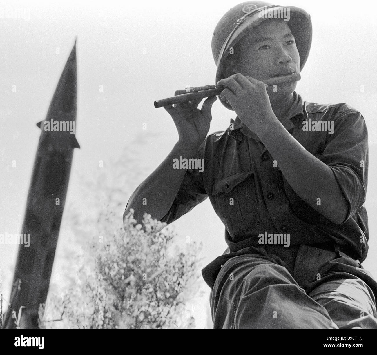A Vietnamese serviceman playing the pipe Stock Photo - Alamy