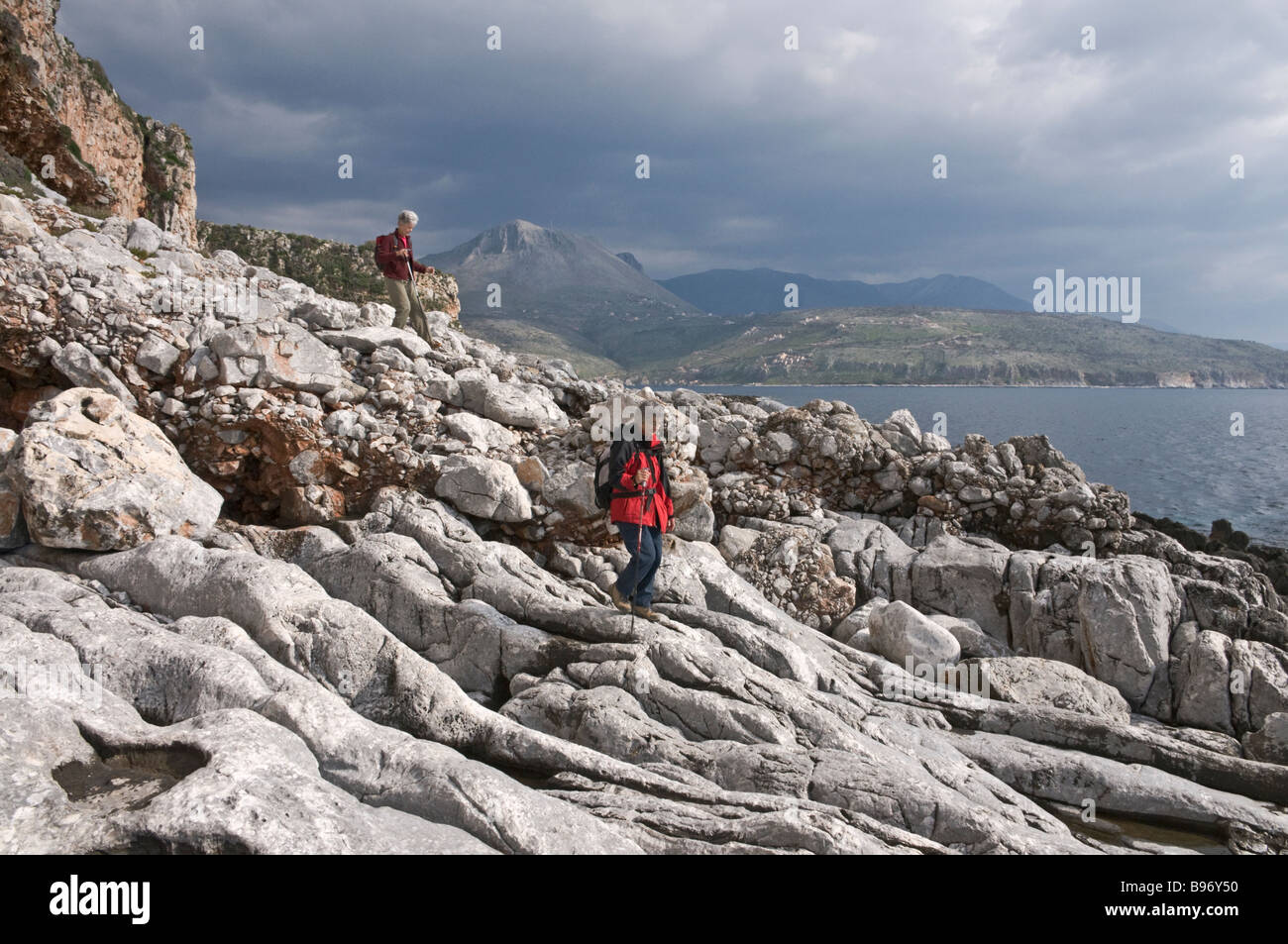 Walkers on the coast on the borders of the Outer and inner Mani near ...
