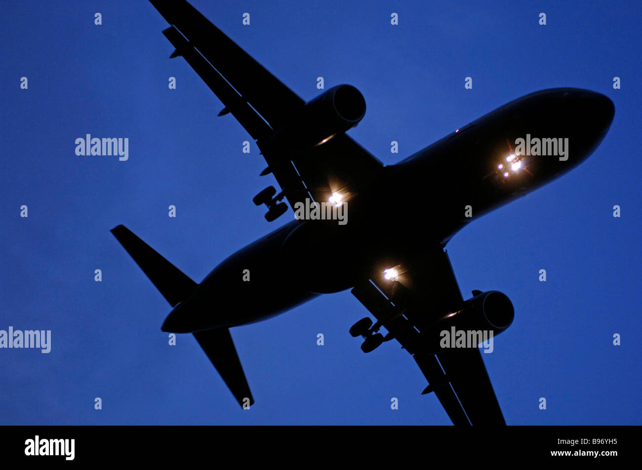 Jet airliner on approach over runway lights at DFW International ...