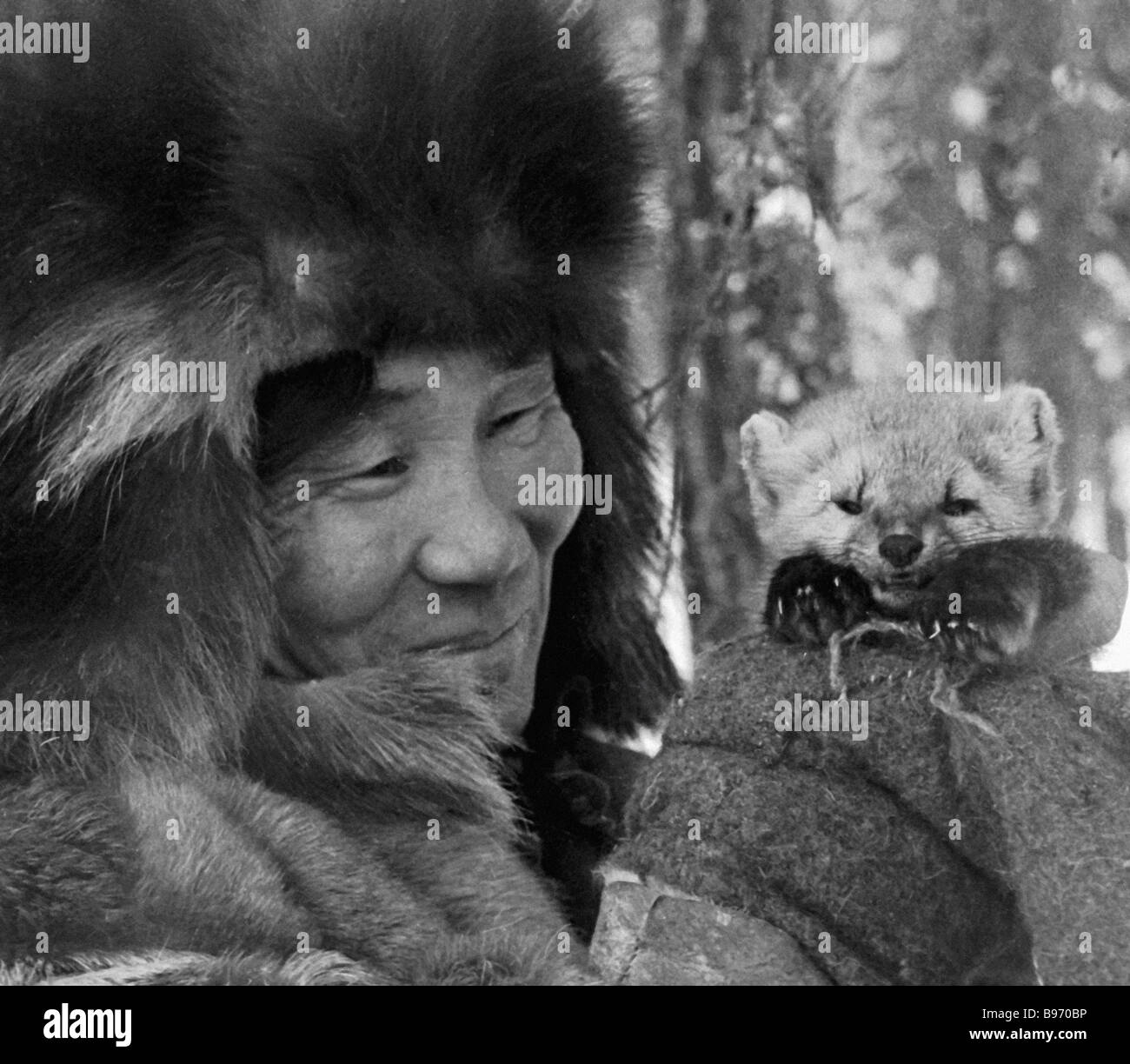 An Evenk hunter holding a sable in his arms Stock Photo - Alamy