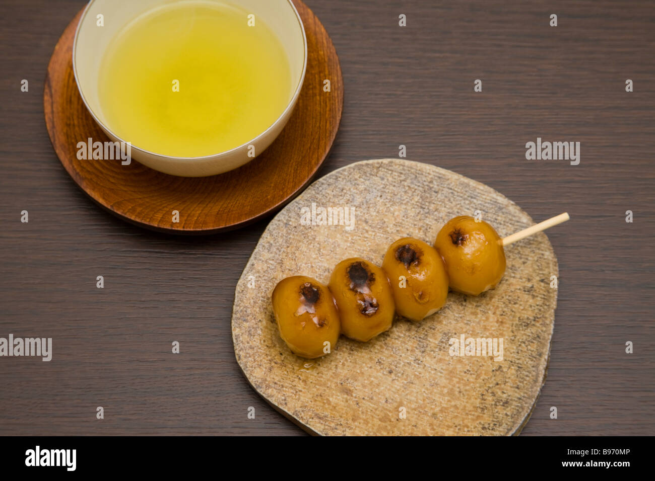 Skewered dumpling with Japanese green tea Stock Photo - Alamy