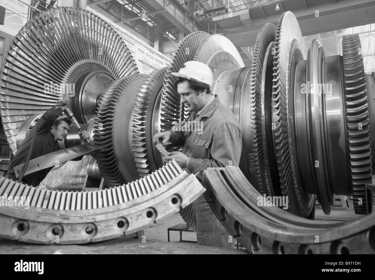 Workers of the Kharkov turbine plant mounting a nuclear turbine rotor ...