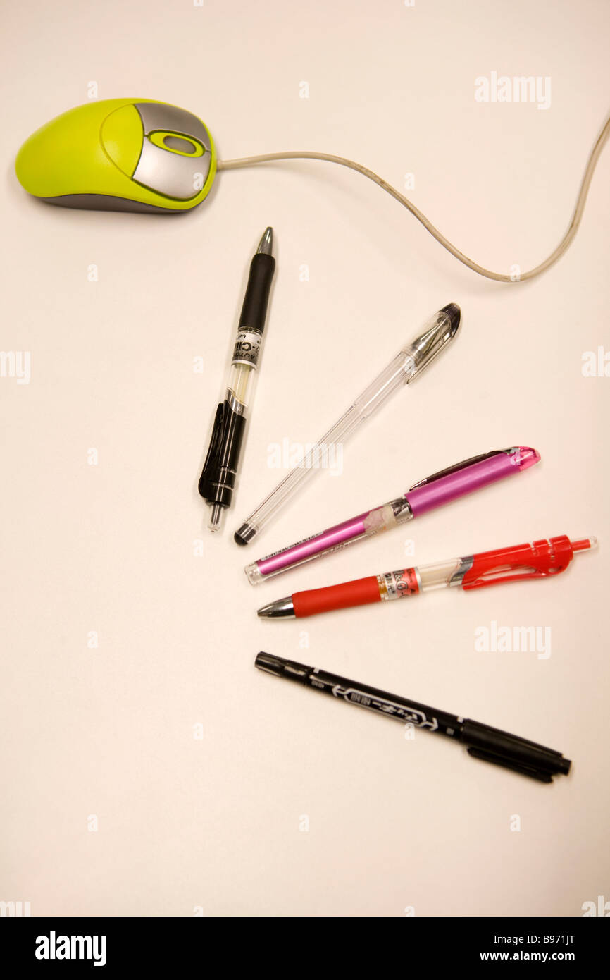 Computer mouse and assorted pens Stock Photo - Alamy