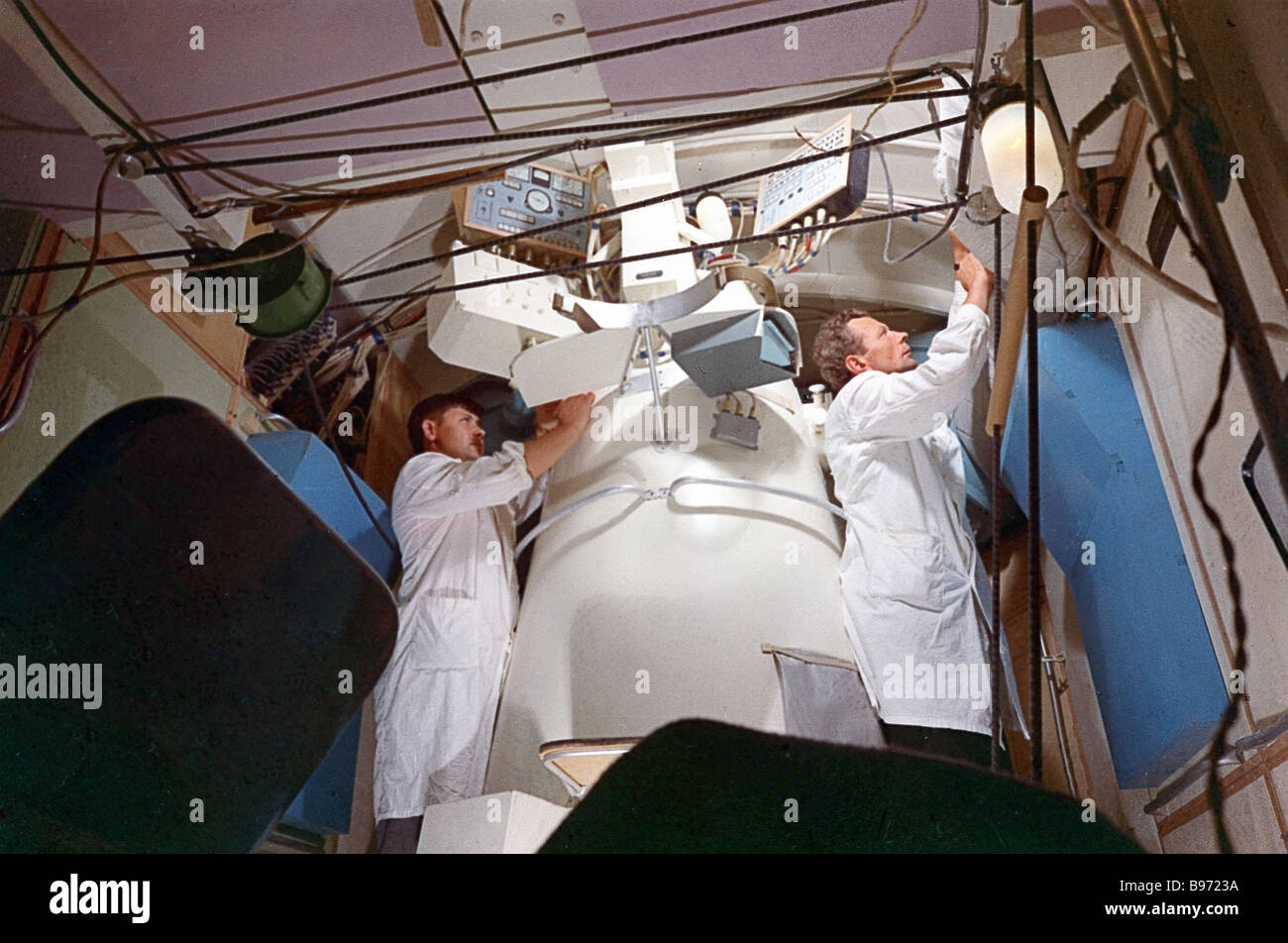 Men at work assembling the orbital station Salyut (launched on April 19 ...