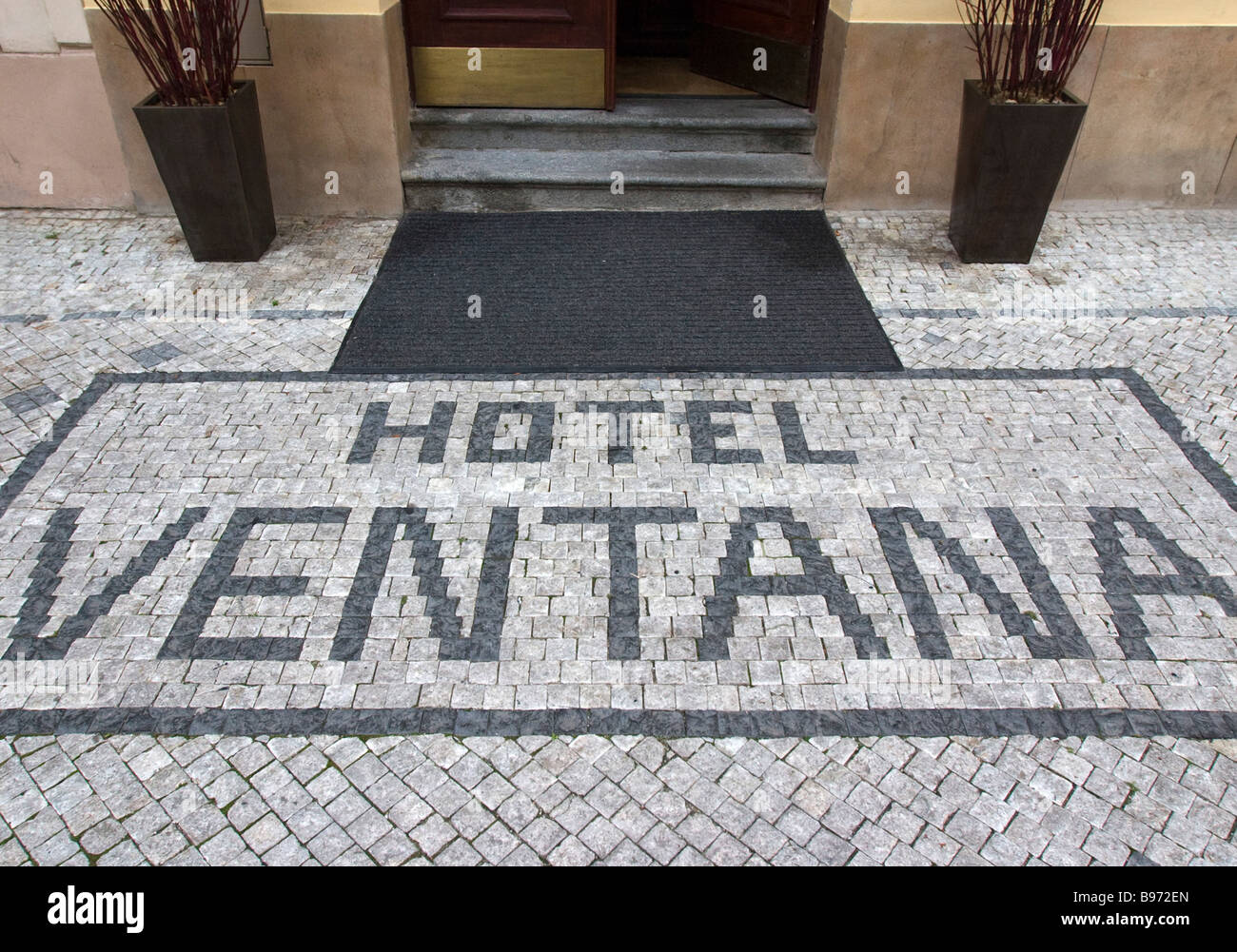 Cobblestone mosaic with hotel advertisment Stock Photo - Alamy