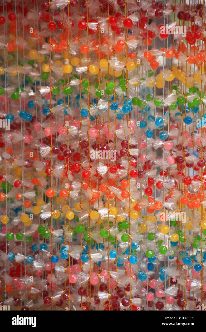 Strings of colorful candy Stock Photo - Alamy