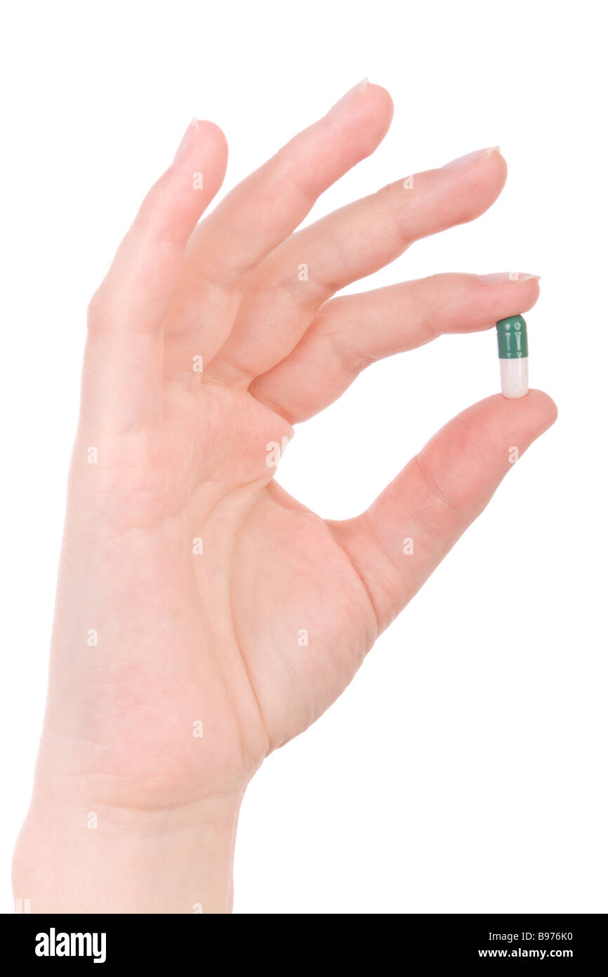 Hand holding a capsule or pill isolated on white Stock Photo - Alamy