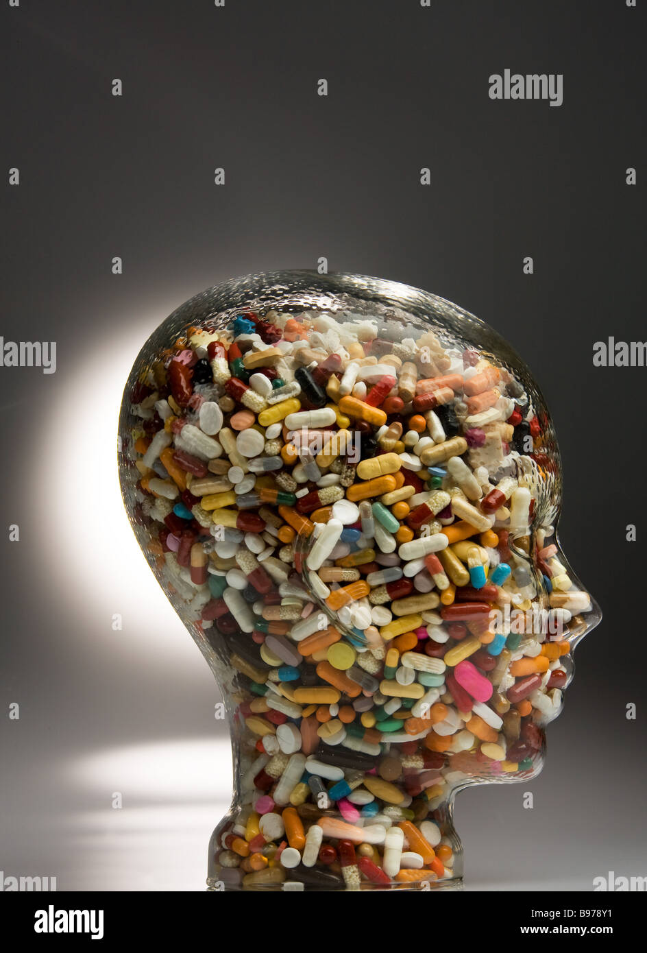 Tablets in a head made of glass Stock Photo - Alamy