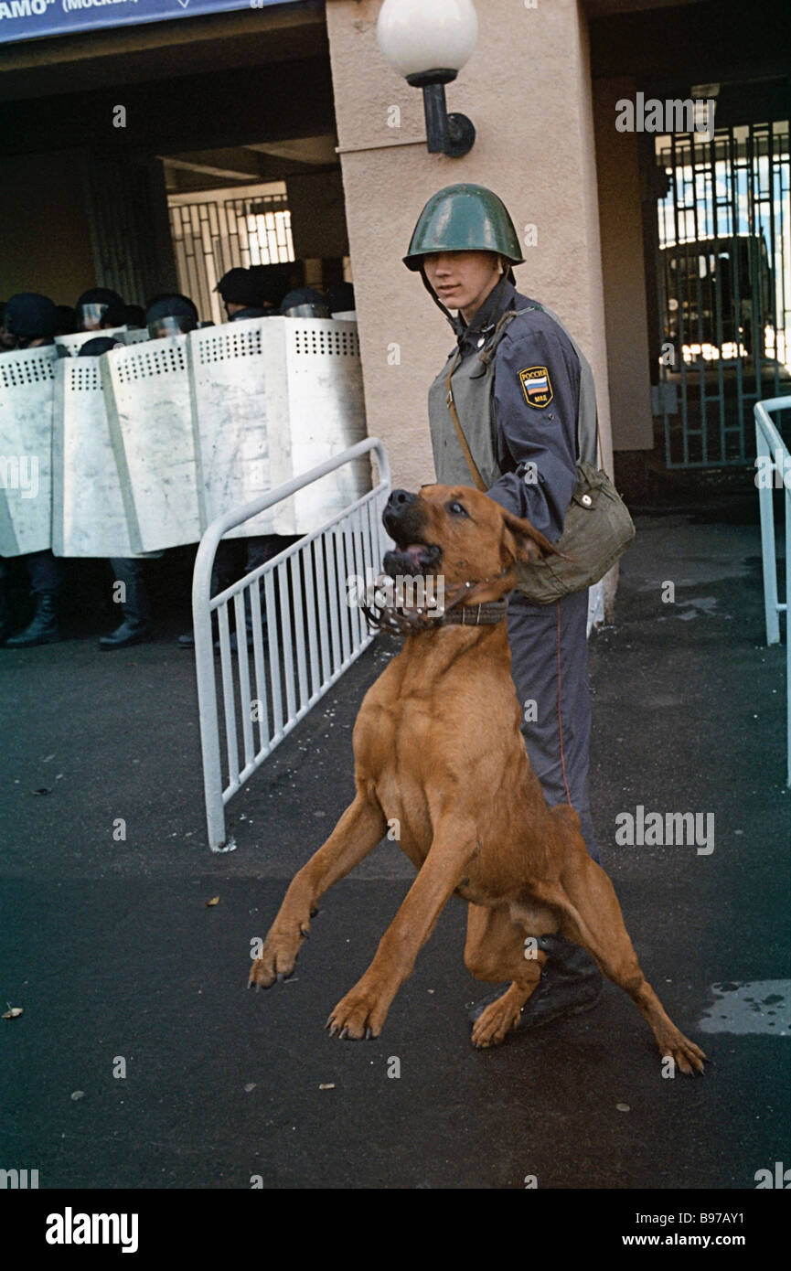 A soldier with a dog during a special riot control exercise of the ...
