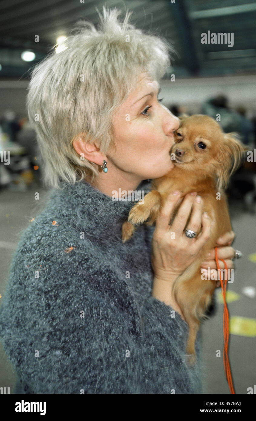 The owner holding a Chihuahua dog in her arms Stock Photo - Alamy