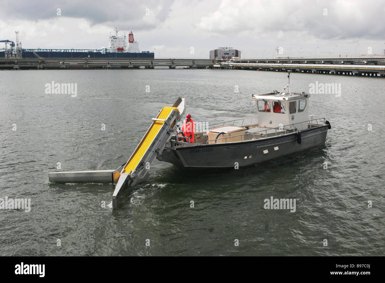 Showing oil spill clean up in the oil loading sea terminal of Primorsk ...