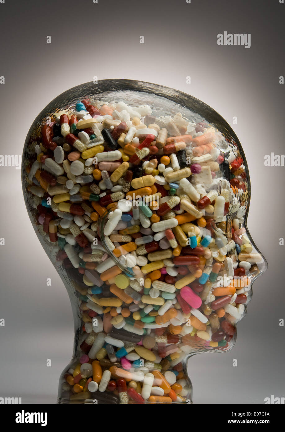 Tablets in a head made of glass Stock Photo - Alamy