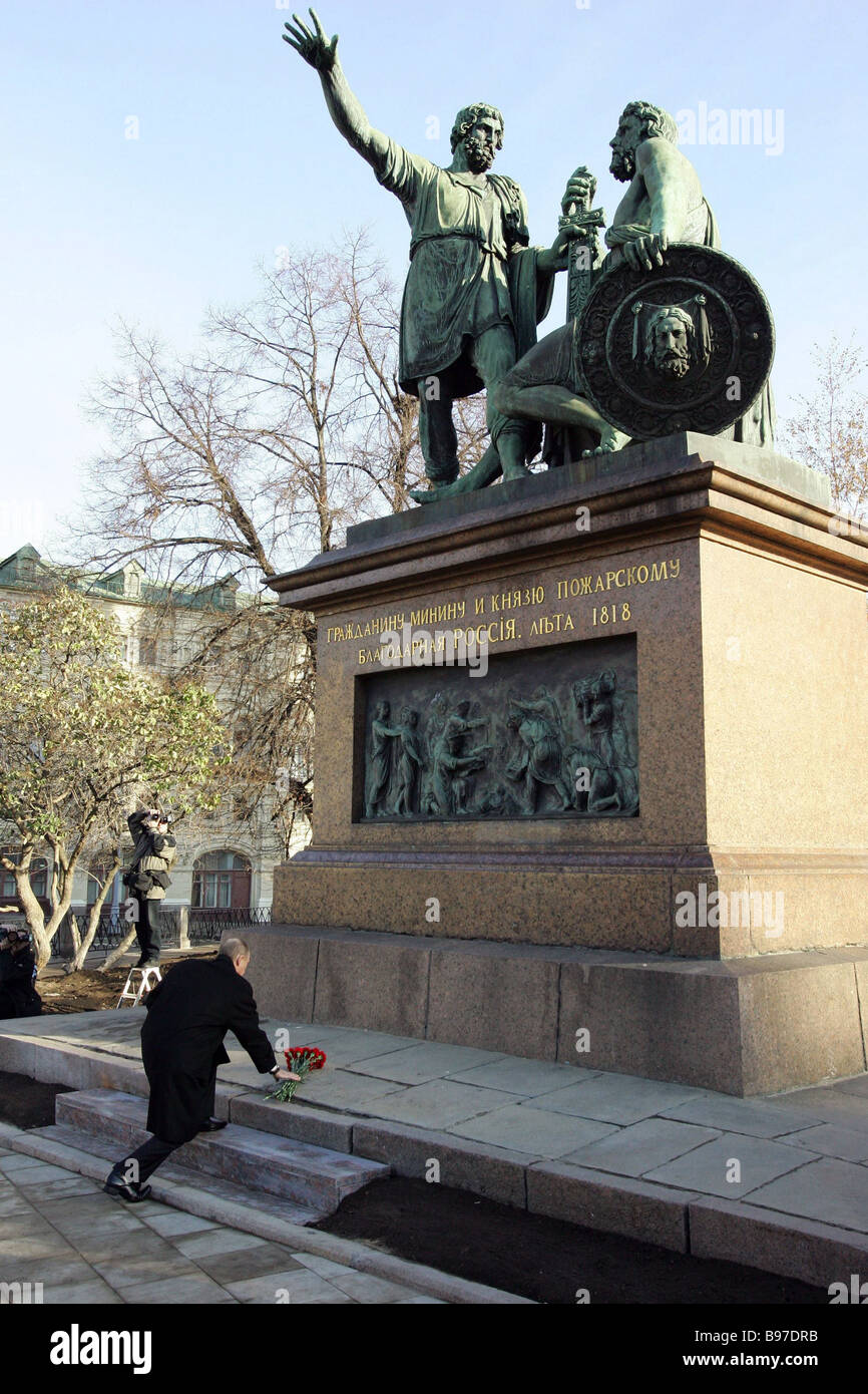 President Vladimir Putin laying flowers to the monument to Minin and ...