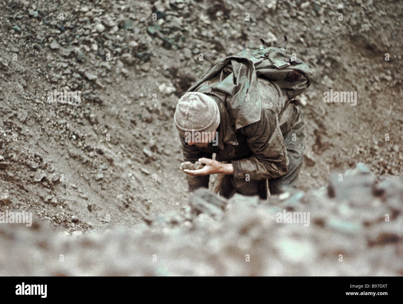 Geologist examines mineral Stock Photo - Alamy
