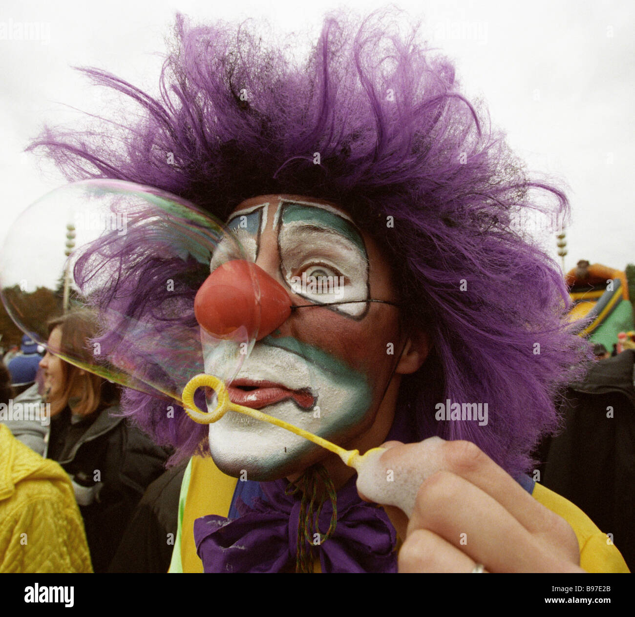 A clown blows soap bubbles during the festive parade of the Moscow ...