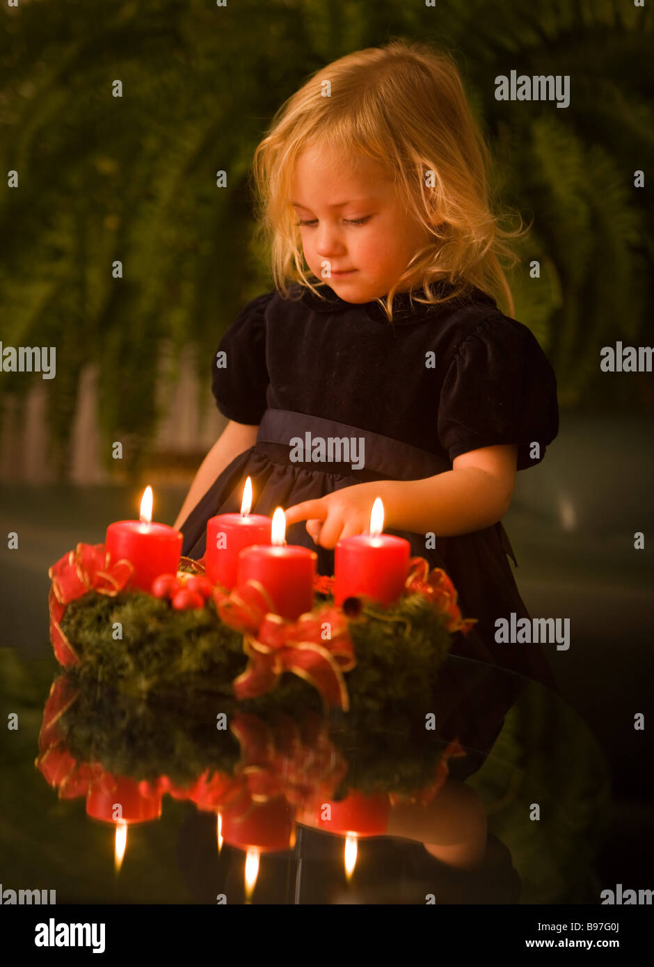 Child with Advent wreath for Christmas Stock Photo - Alamy