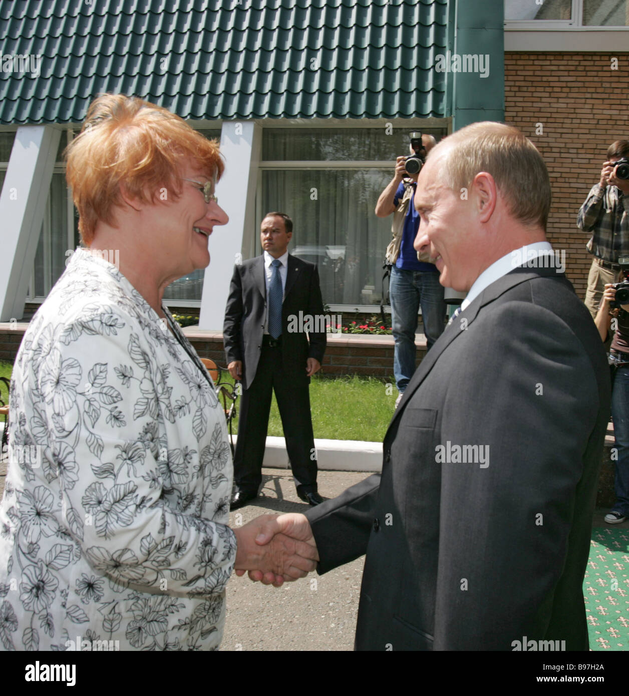 Russian President Vladimir Putin greeting Finnish President Tarja ...