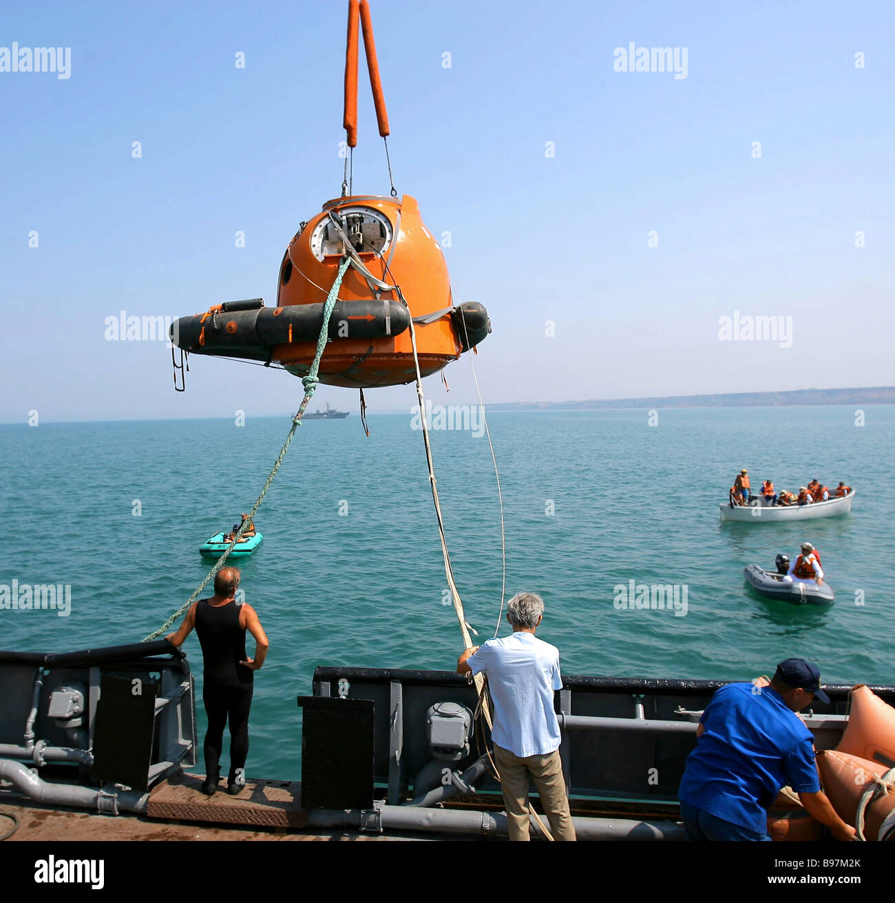 The Soyuz descent vehicle is lowered into water as international space ...