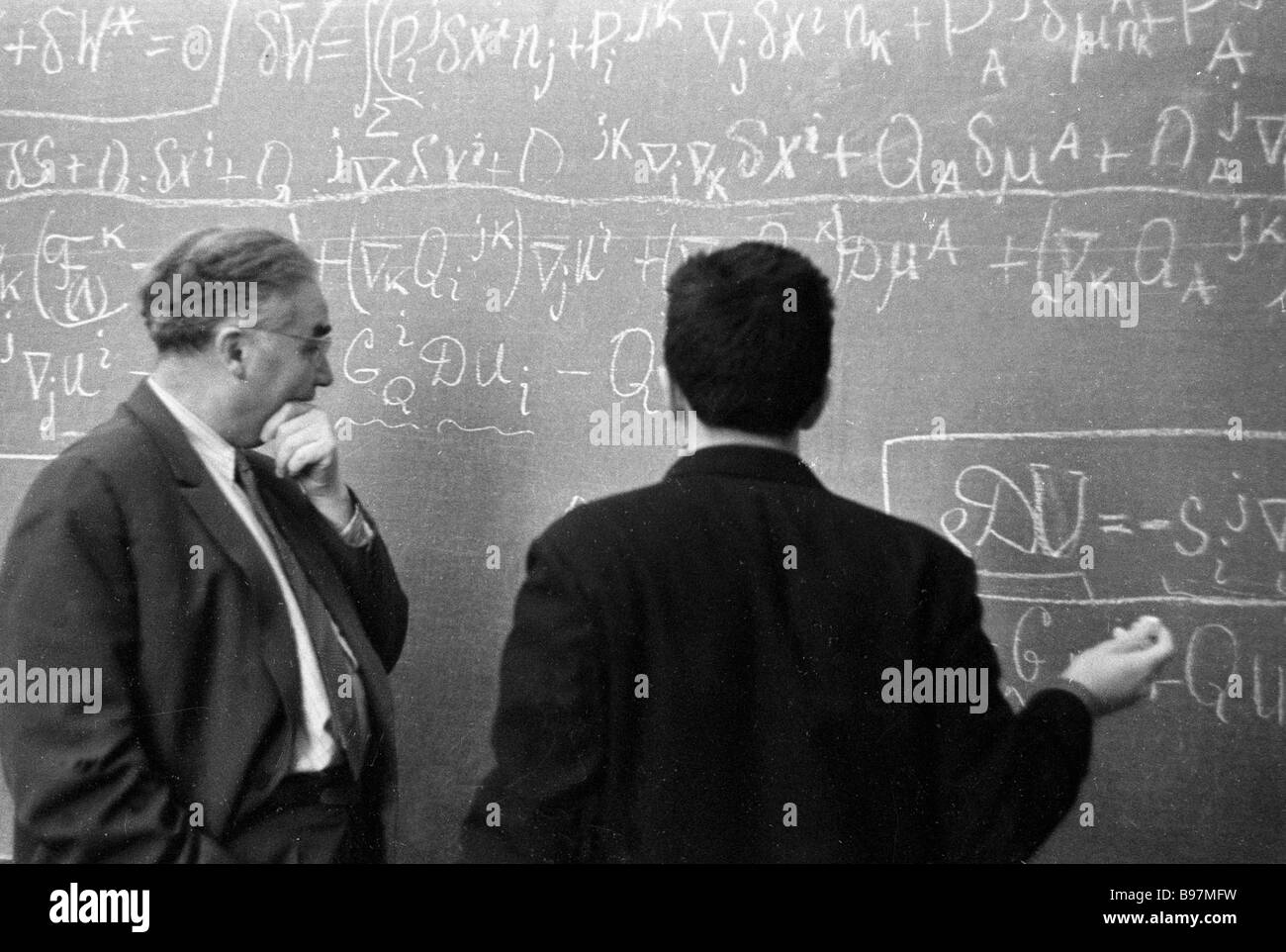Academician Leonid Sedov left helping a student with equation Stock ...