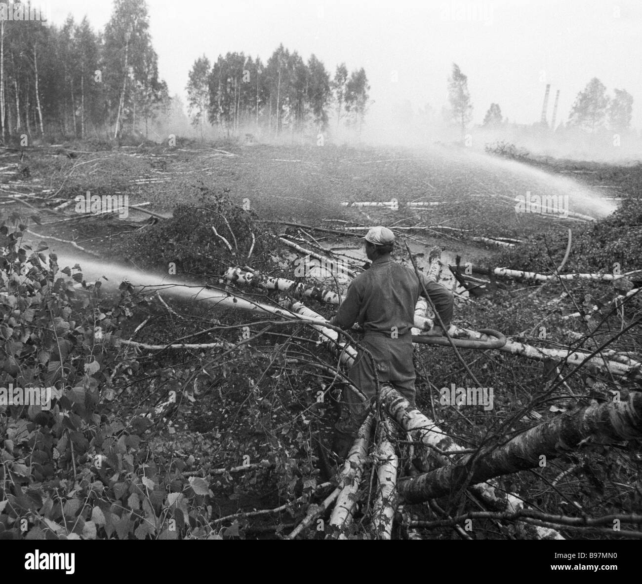 A soldier from the independent military fire brigade 33 extinguishing a ...