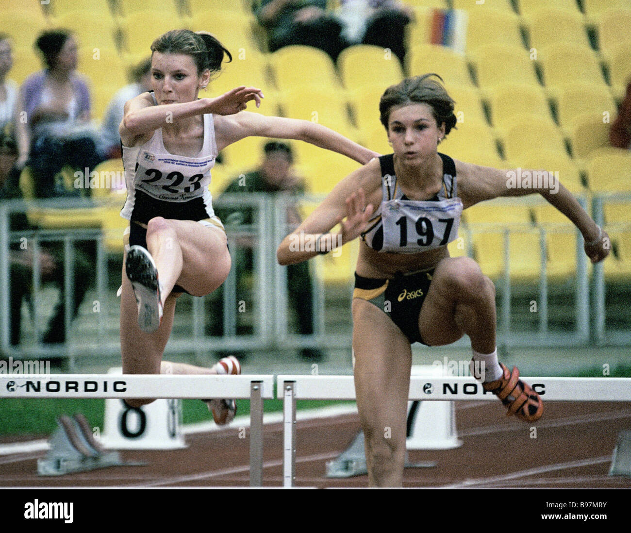 Participants of the International Junior sports games in a hurdles race ...