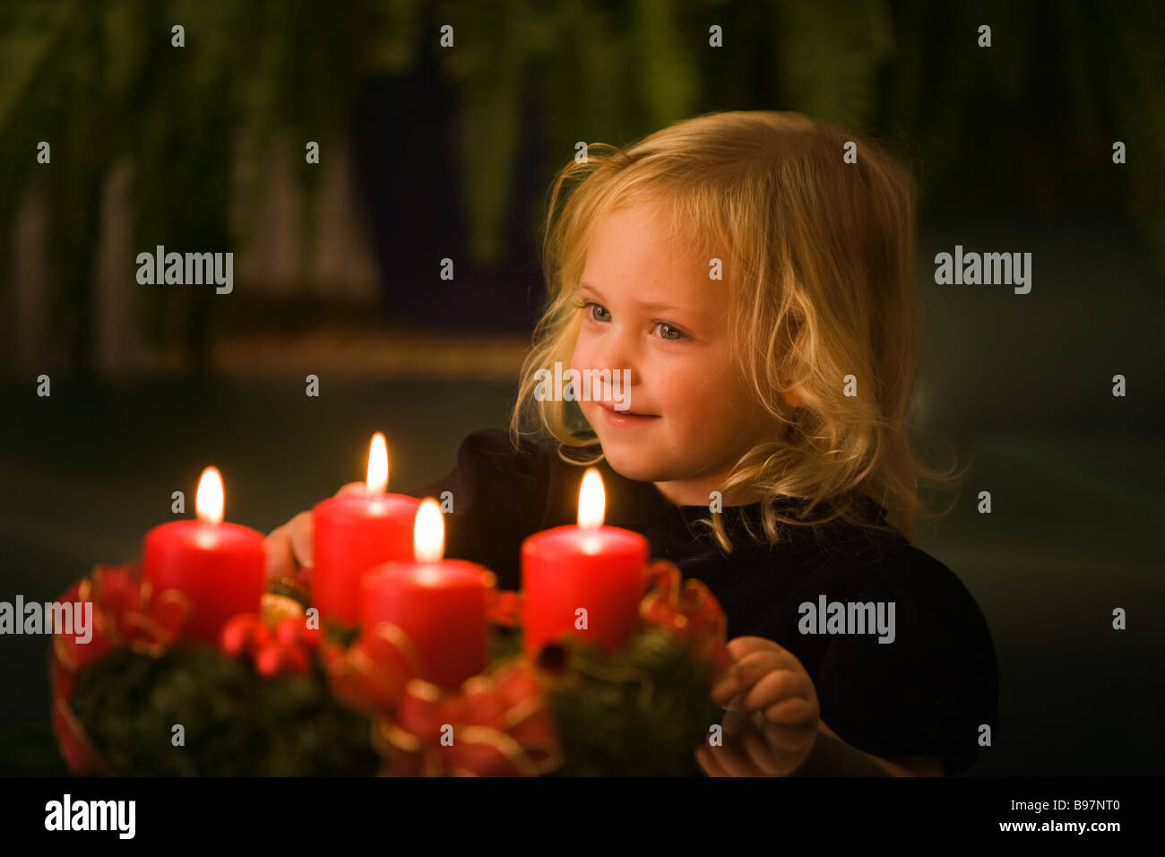 Child with Advent wreath for Christmas Stock Photo - Alamy