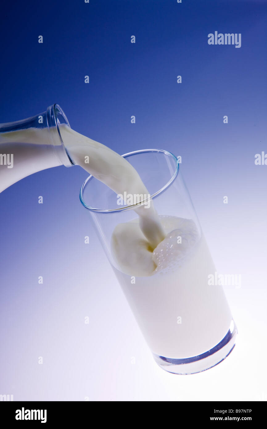 Fresh milk is poured into a glass Stock Photo - Alamy