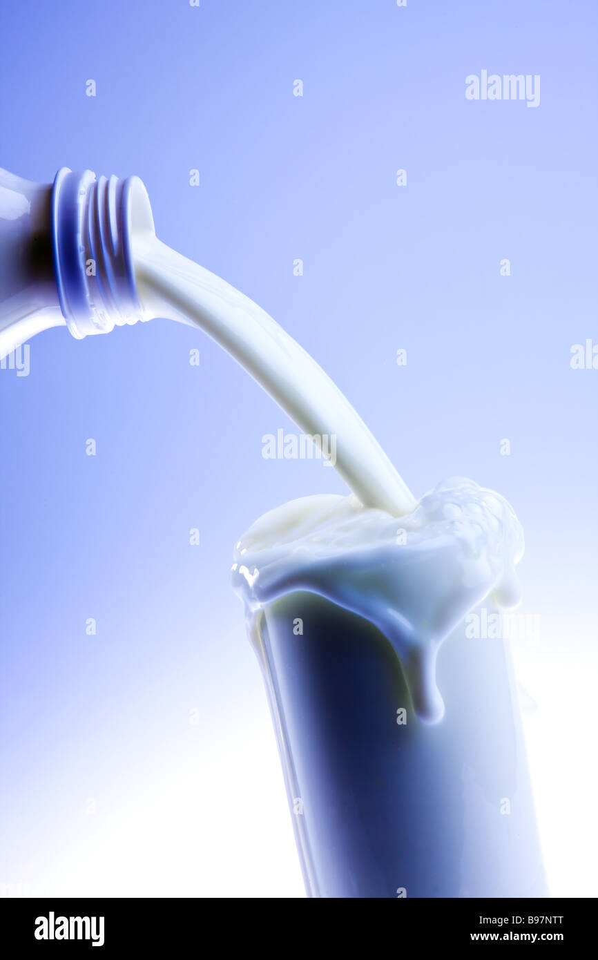 Fresh milk is poured into a glass Stock Photo - Alamy